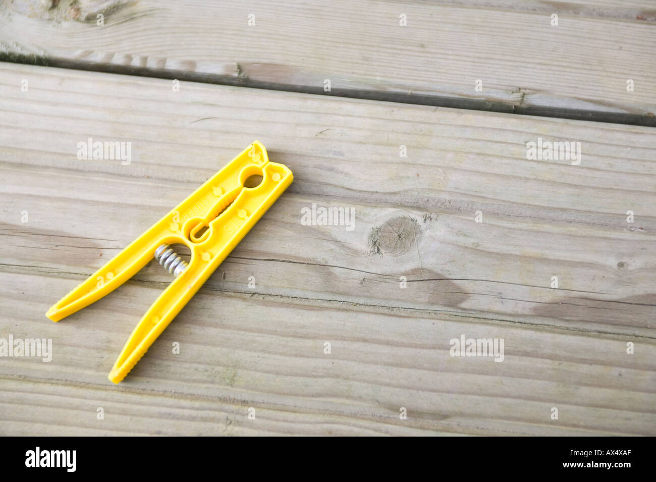 Yellow peg on wooden floor Stock Photo - Alamy