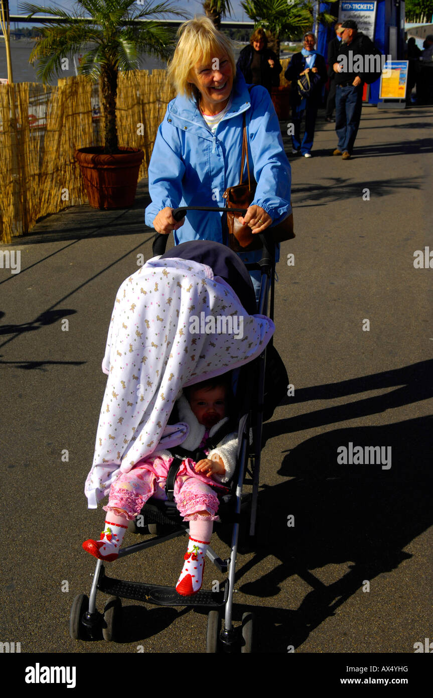 grandmother pushing pram grandaughter summer dusseldorf extended family ...