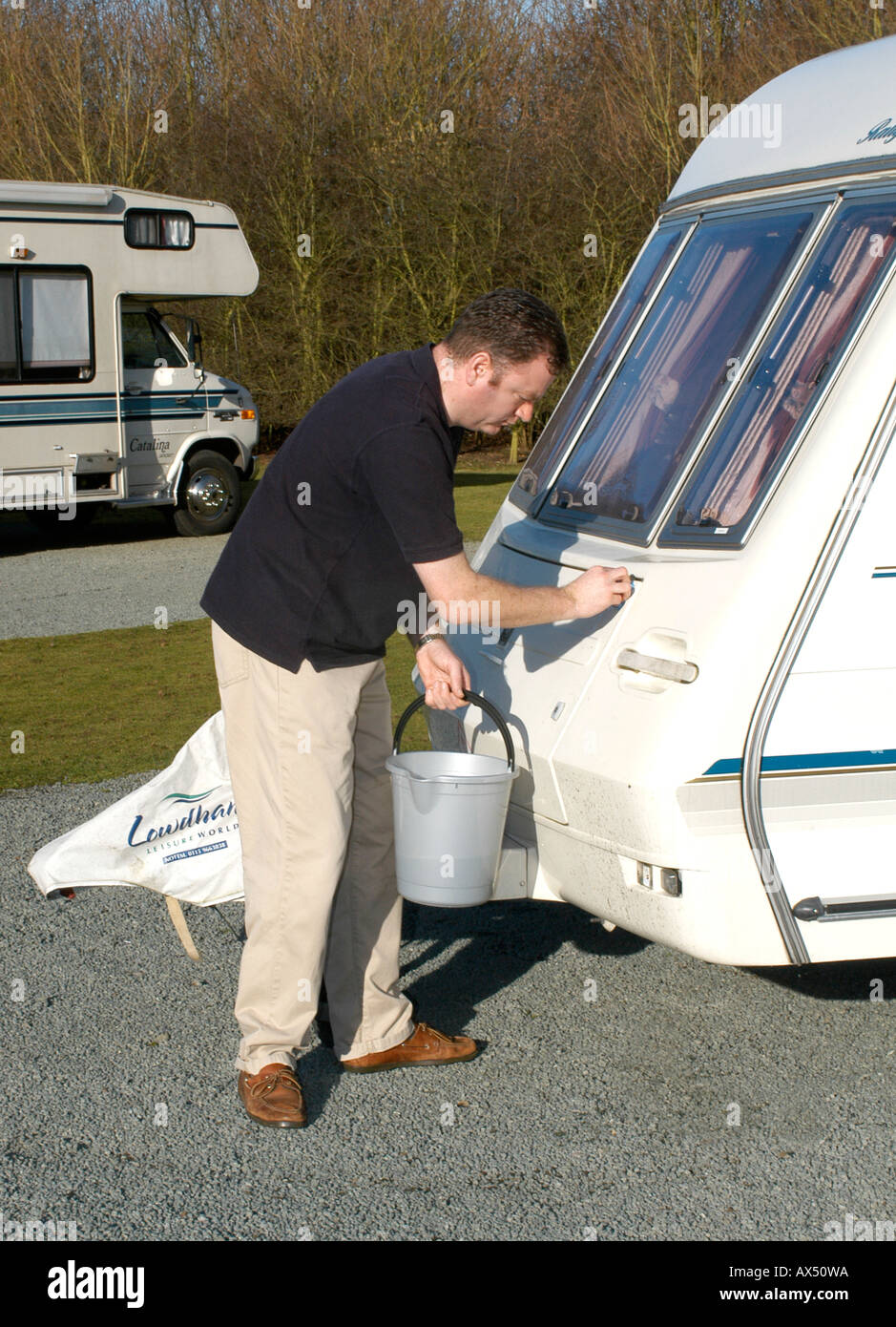 Man cleaning his caravan Stock Photo - Alamy