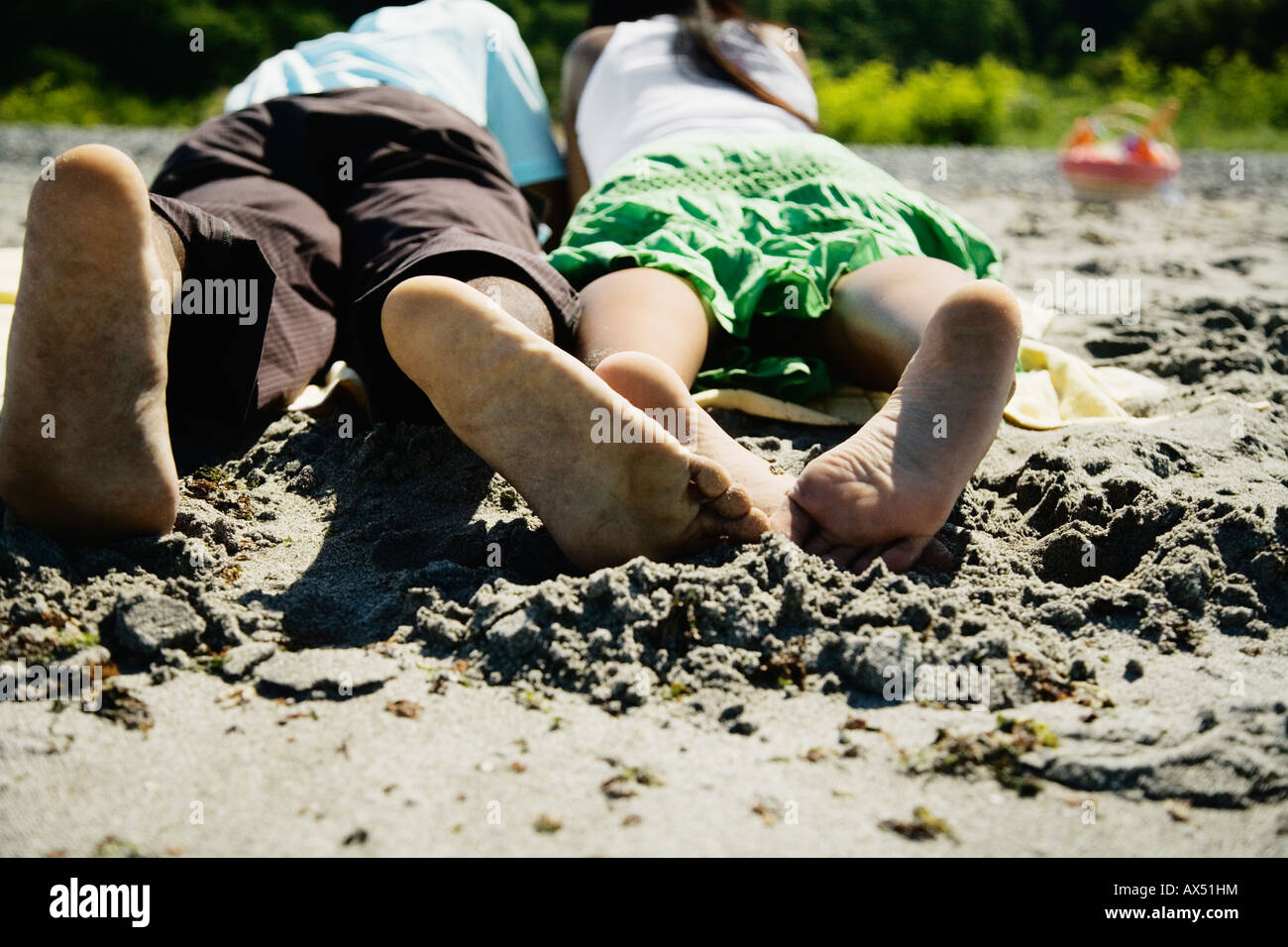 African couple laying on beach Stock Photo - Alamy
