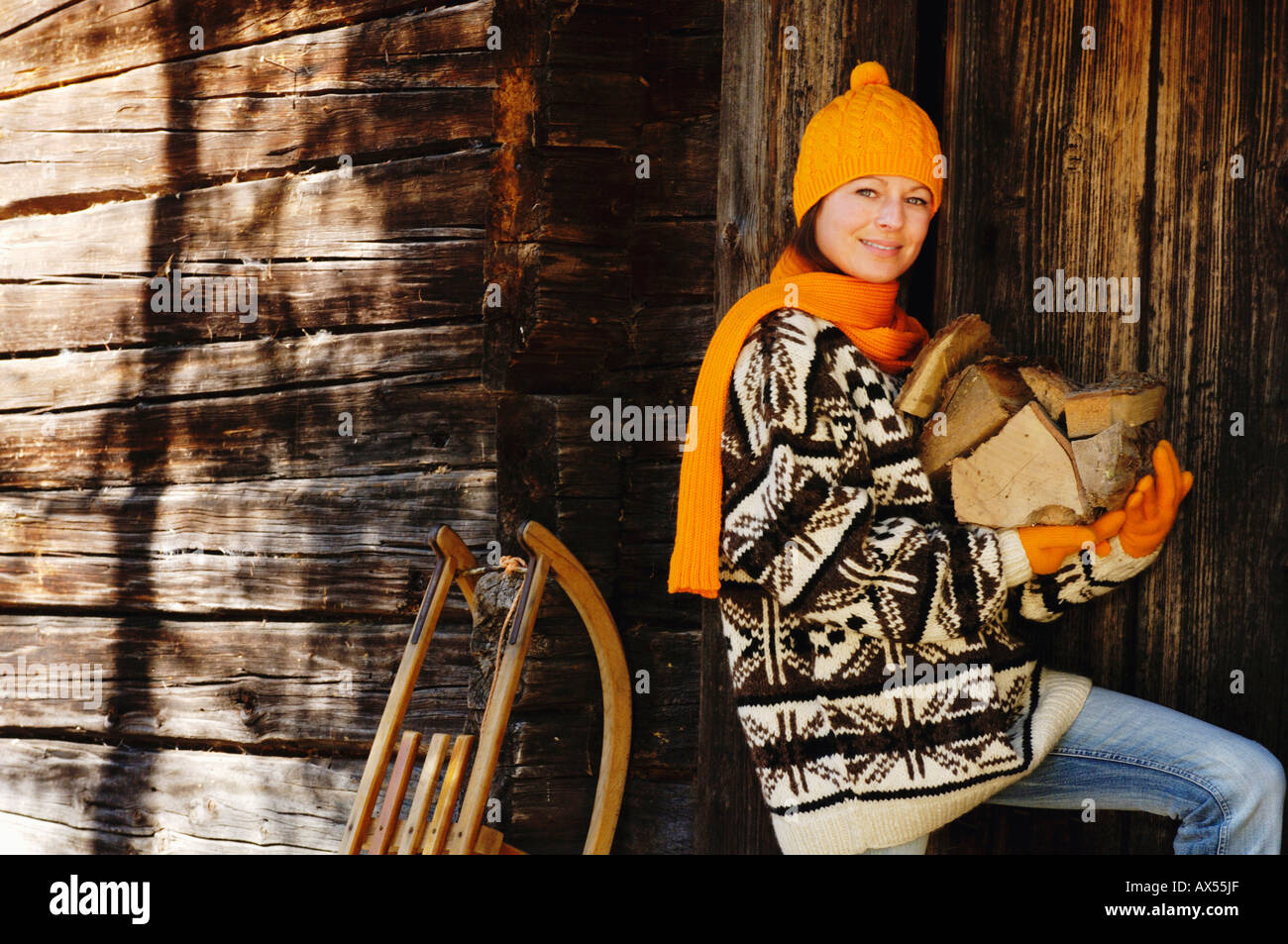 Young woman carrying firewood, portrait Stock Photo - Alamy