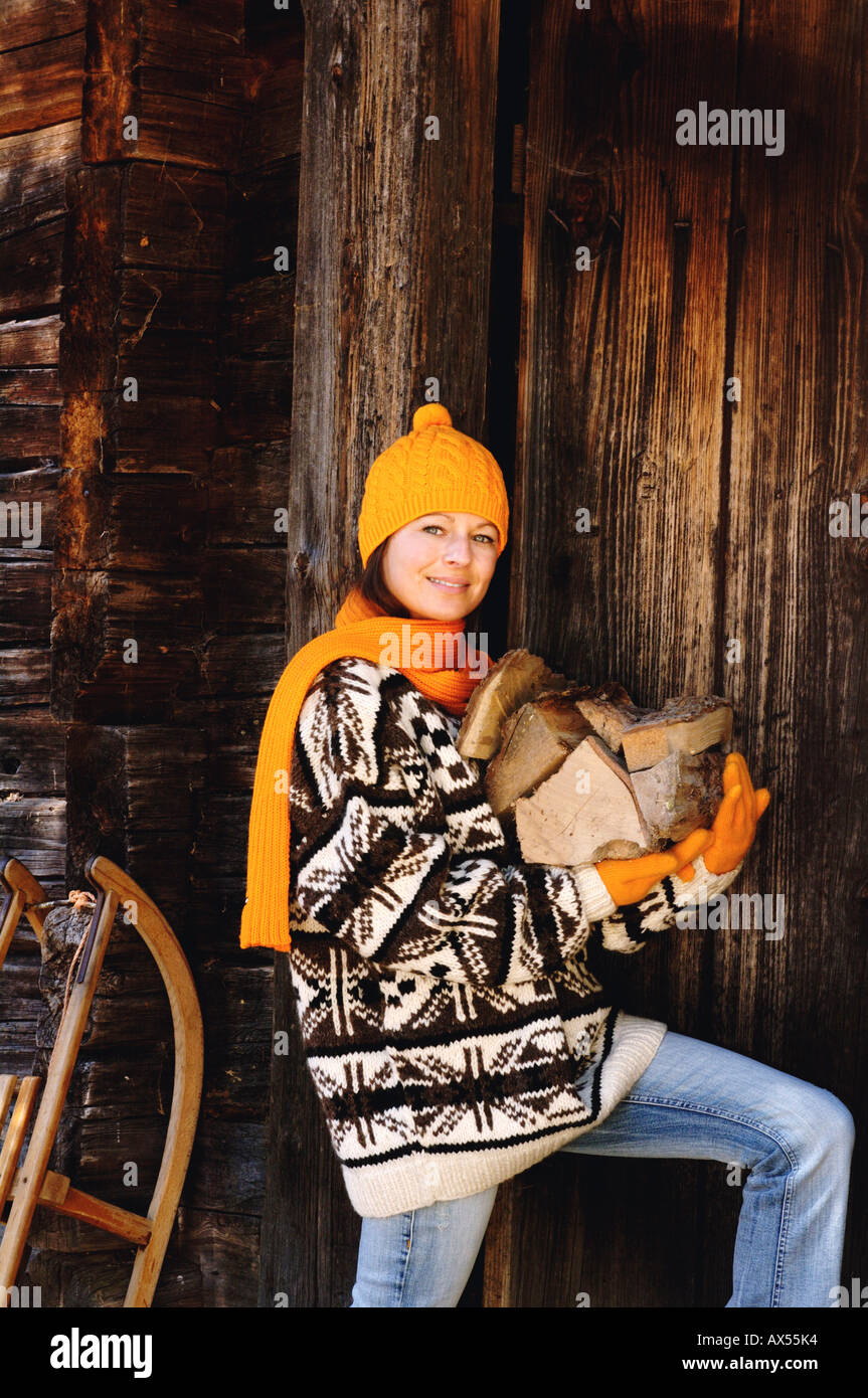 Young woman carrying firewood hi-res stock photography and images - Alamy