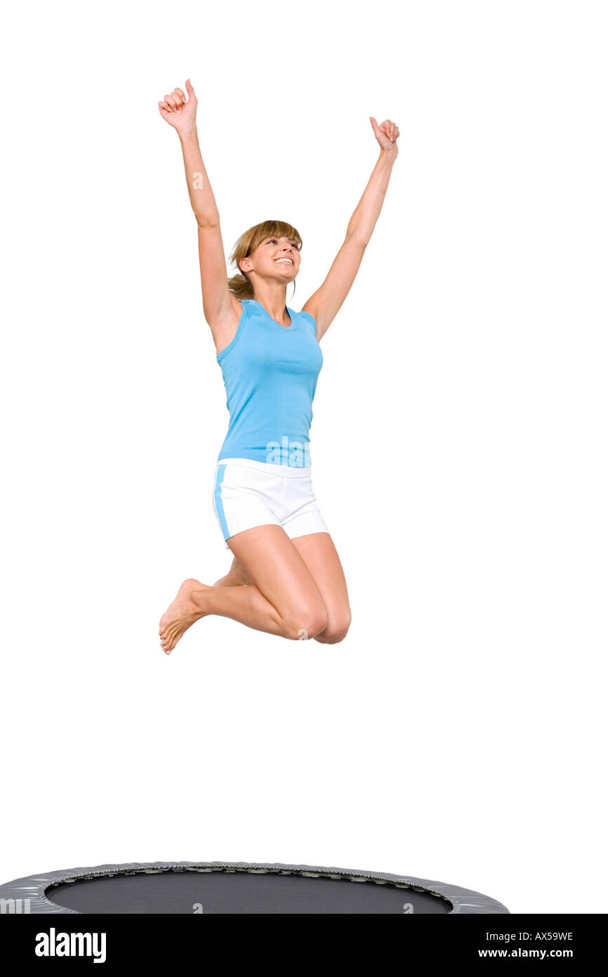 Young woman jumping on trampoline, low angle view Stock Photo - Alamy