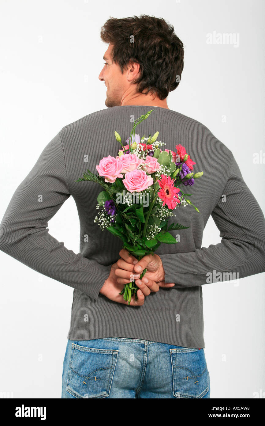 Man holding flowers behind back hi-res stock photography and images - Alamy