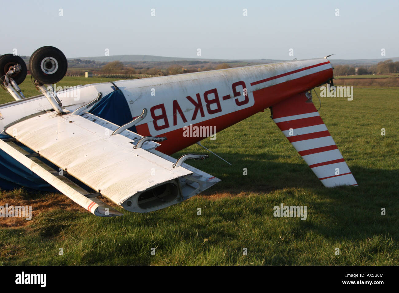 Small Airplane crash upside down on airfield, blown by gust of wind ...