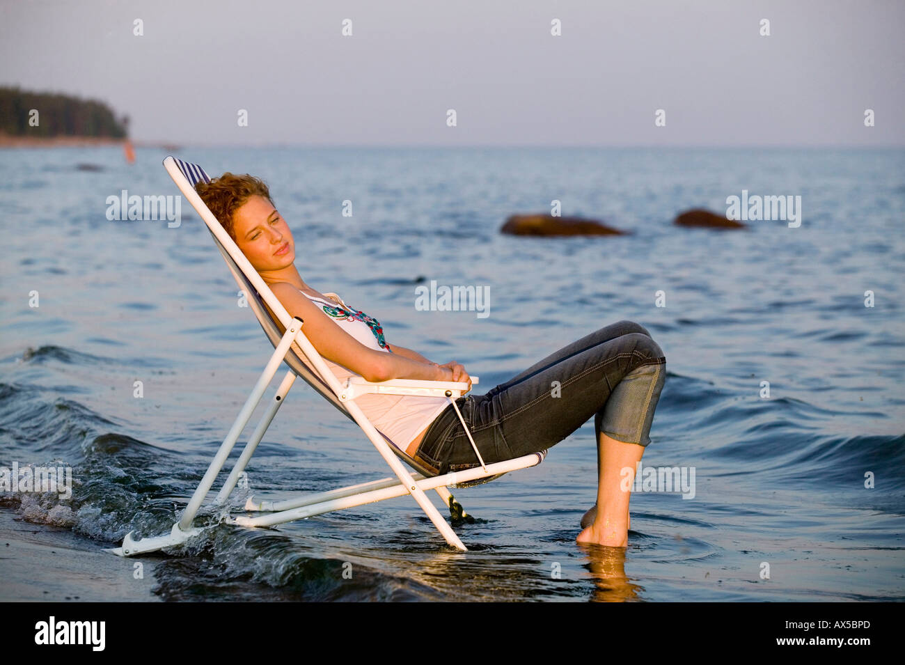 Curled up relaxing in chair hi-res stock photography and images - Alamy