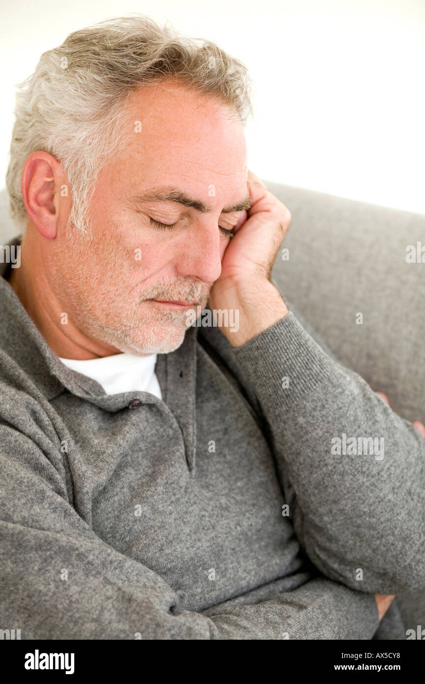 Mature man having nap on sofa, elevated view, close-up Stock Photo - Alamy