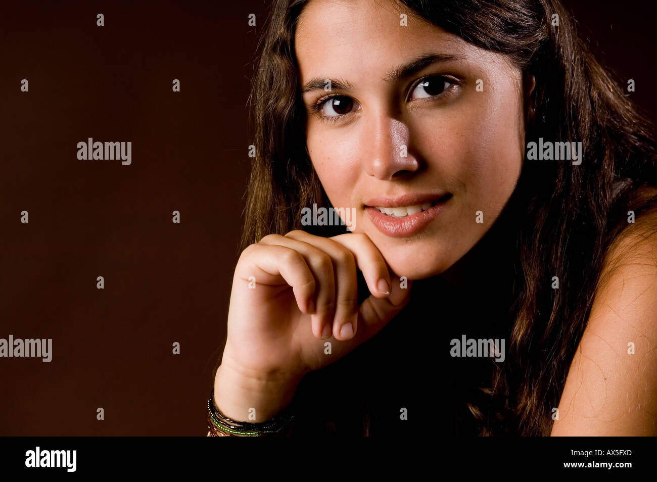 A beautiful young woman on a brown backdrop Stock Photo - Alamy