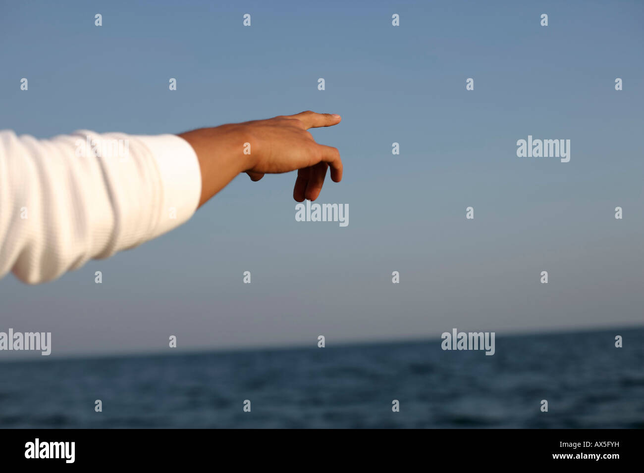 Man pointing to sea Stock Photo - Alamy