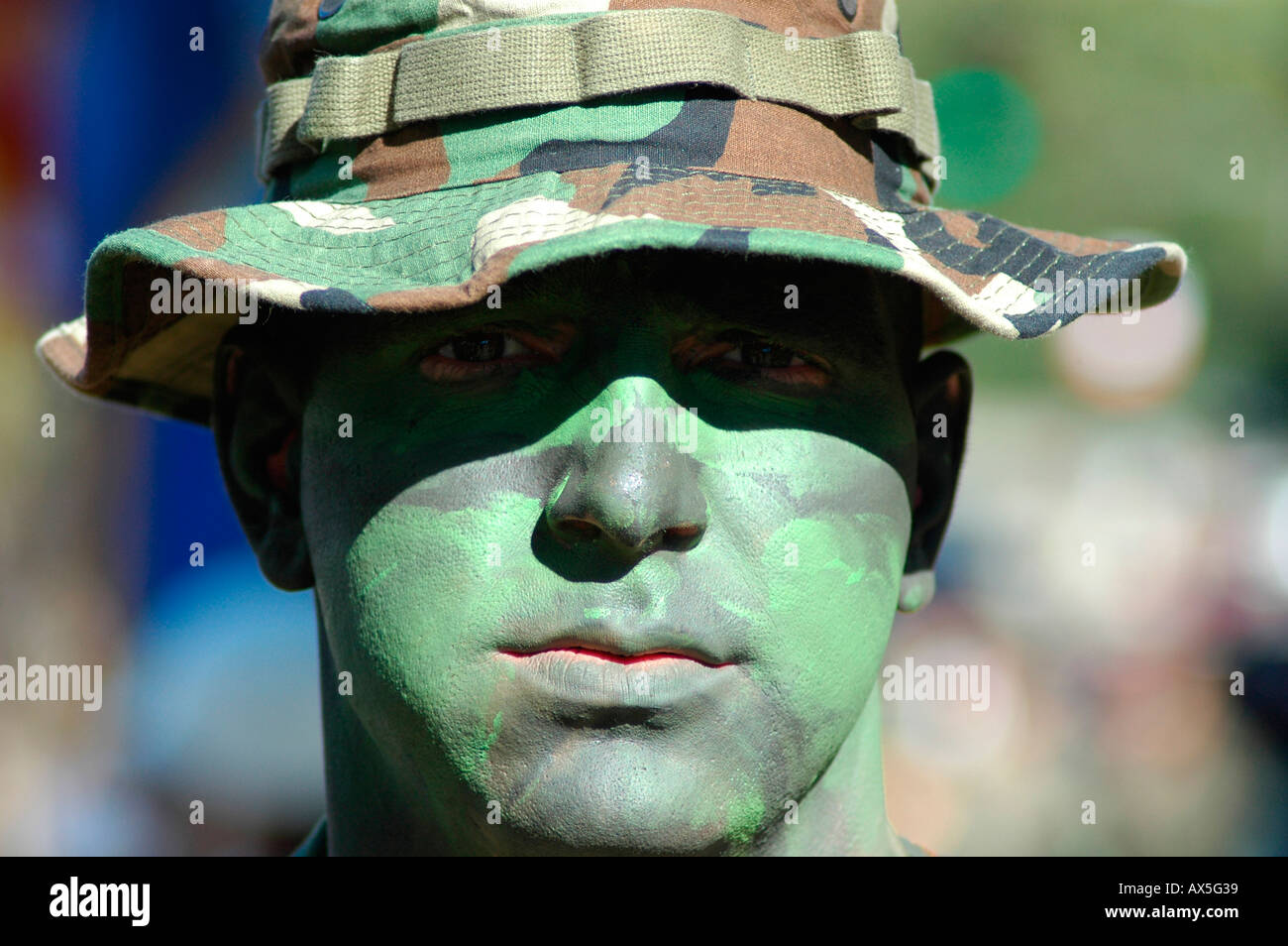 Young soldier in camouflaged face paint in formation about to go to war ...