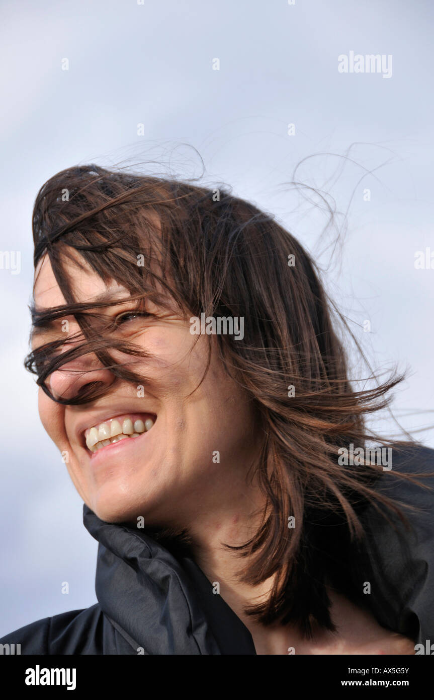 Woman laughing, hair ruffled by the wind Stock Photo - Alamy