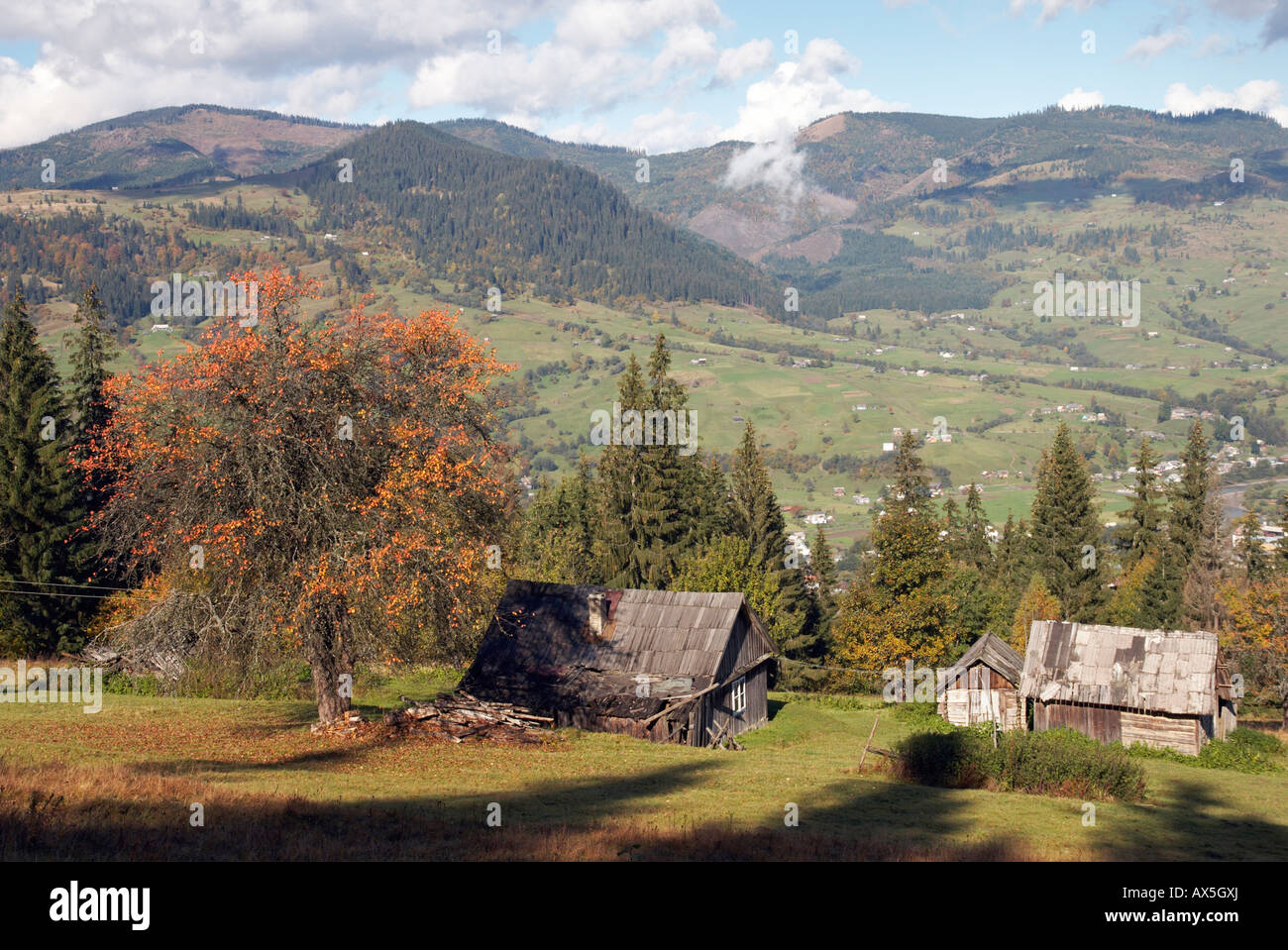 Autumn mountainous green glade with small country estate Stock Photo ...