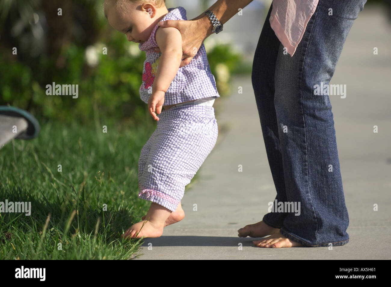baby touching grass with feet Stock Photo - Alamy