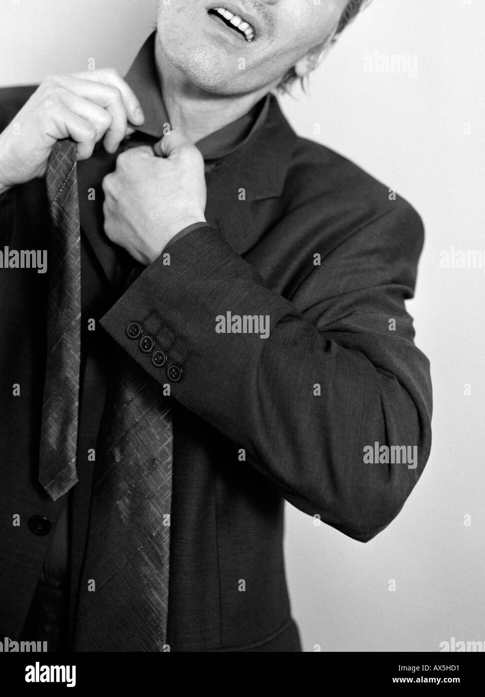 Man tying necktie Stock Photo - Alamy