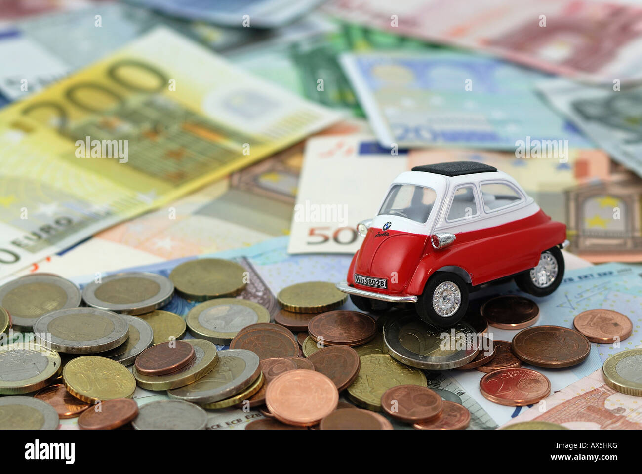 Model car with Euro notes and coins Stock Photo - Alamy
