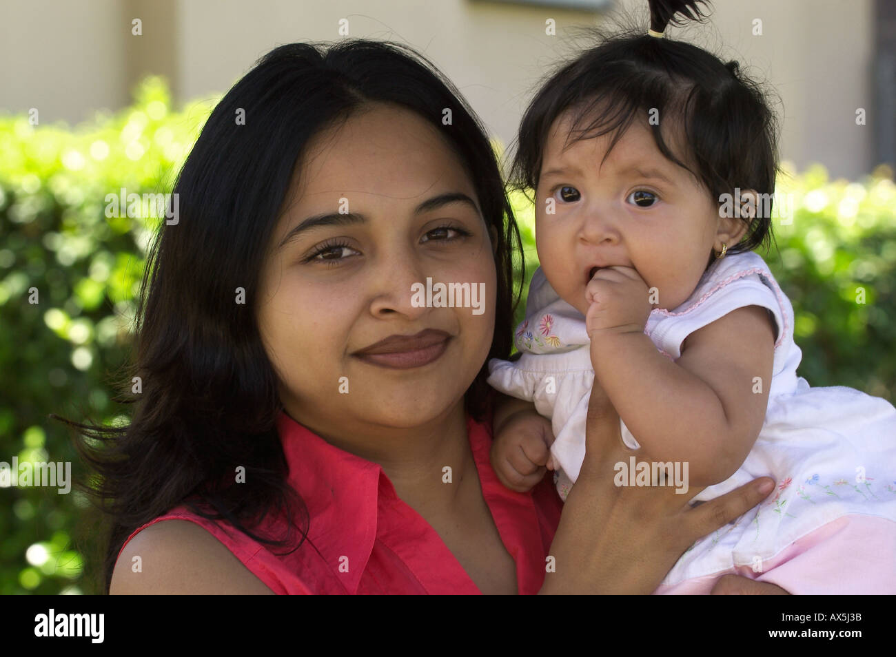 Hispanic mother with baby Stock Photo - Alamy
