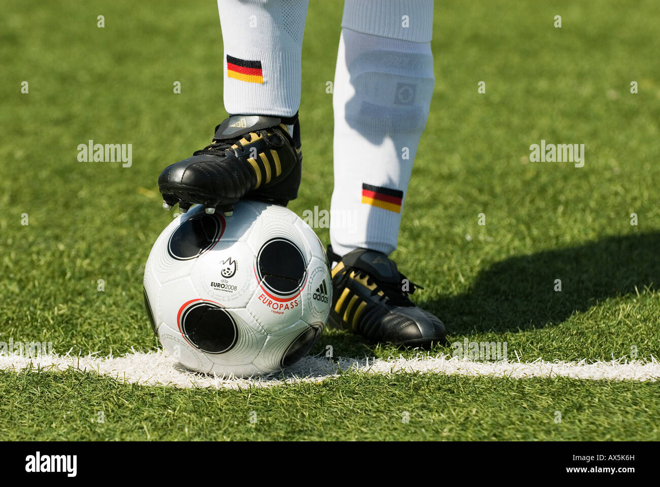 foot of a german national football player stands on a copy of EUROPASS ...