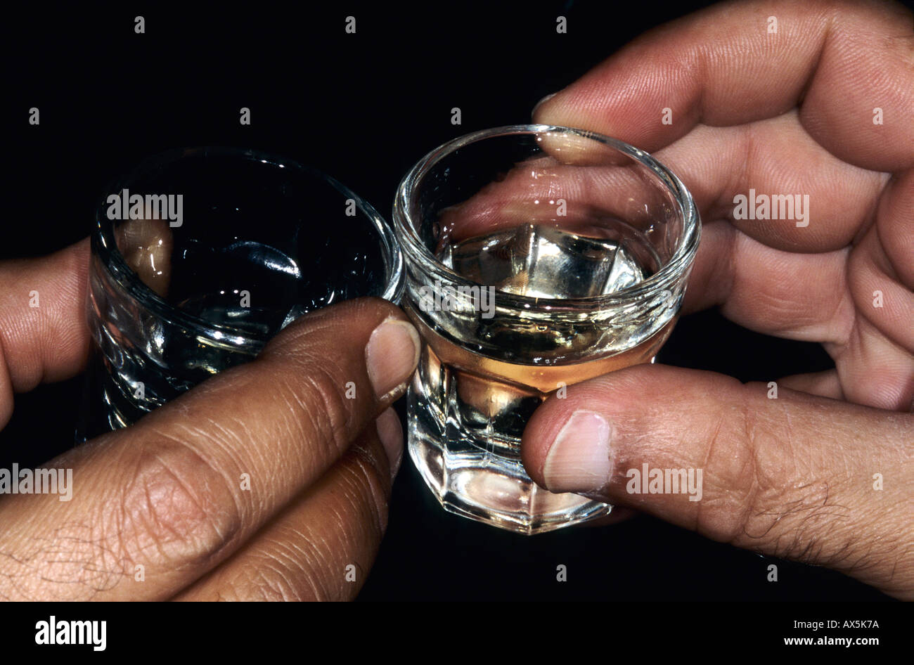 Shot glasses clinking hi-res stock photography and images - Alamy