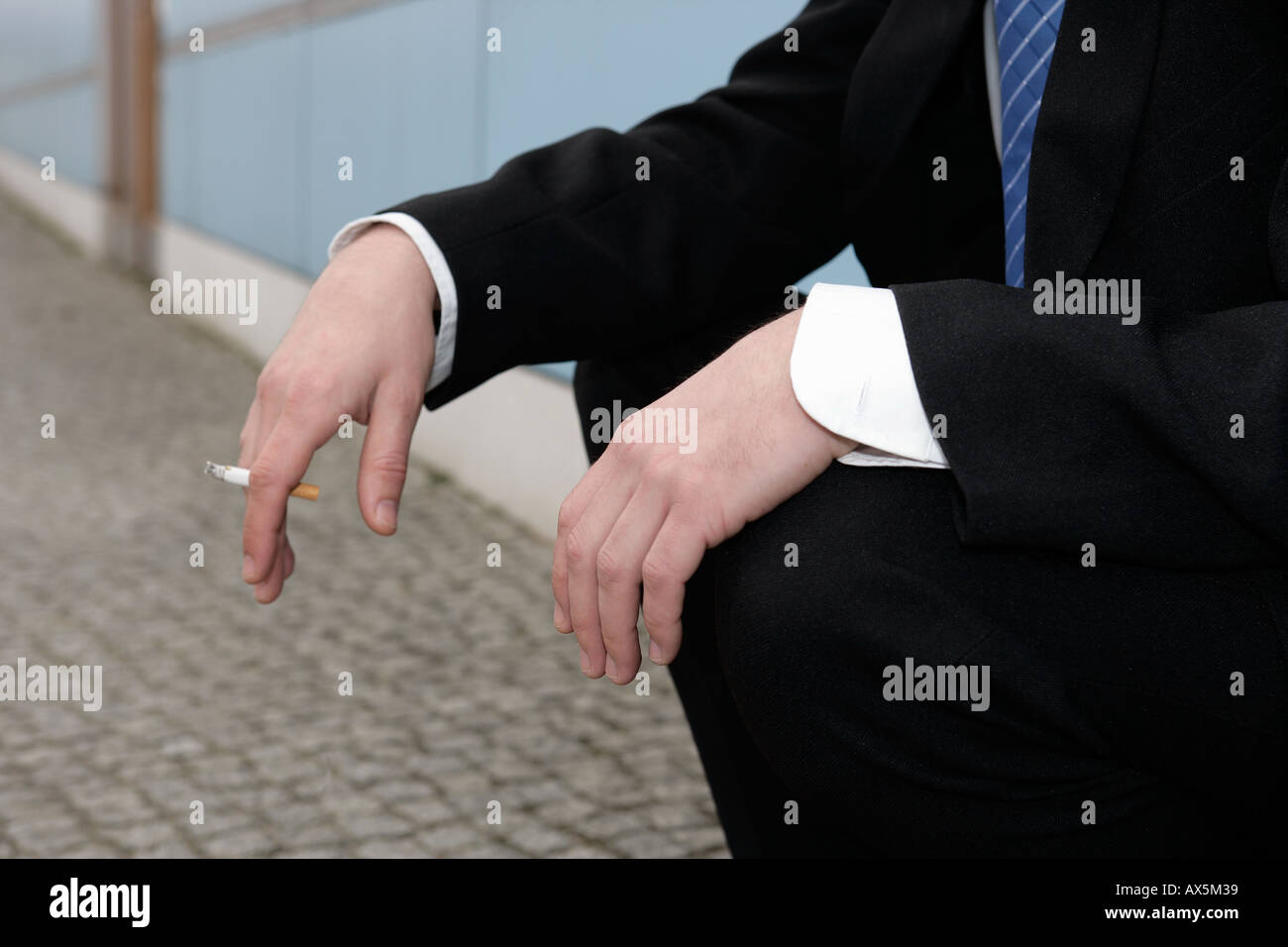 Man squatting smoking cigarette smoking hi-res stock photography and ...