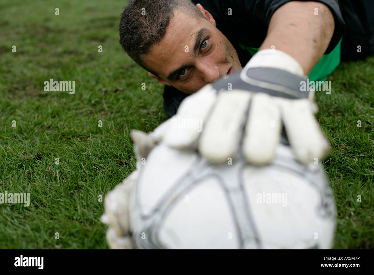 Goalkeeper catching a football Stock Photo - Alamy