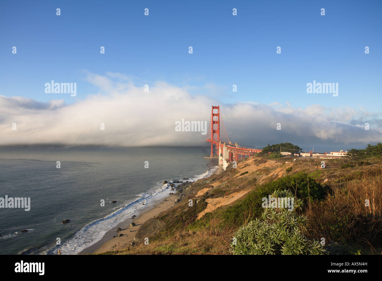 Coastal bluffs on a clear day with fog rolling through the Golden Gate ...