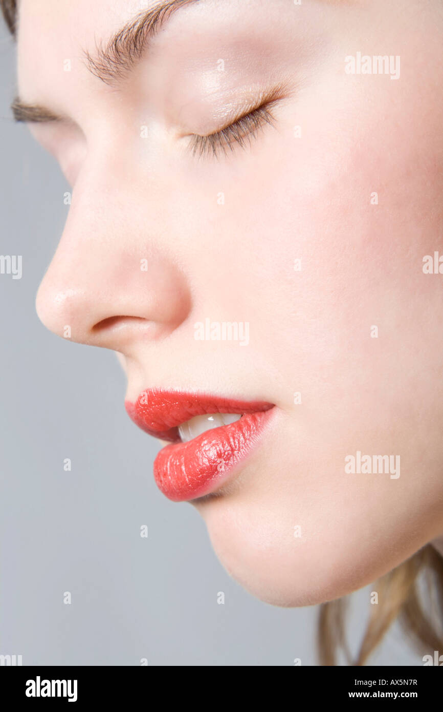 Close-up of young woman's face, profile, eyes closed, red lips Stock Photo - Alamy