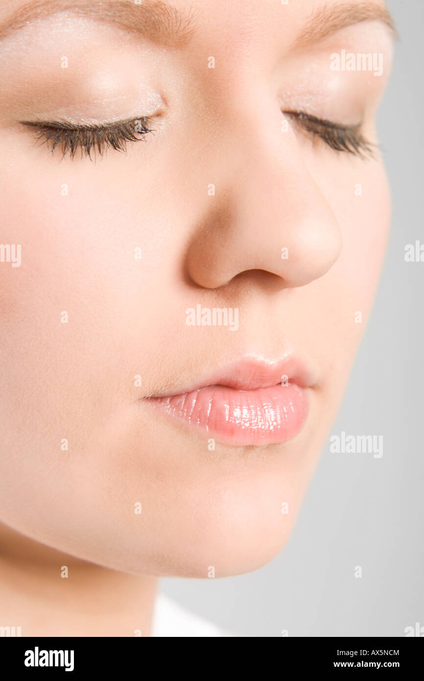 Close-up of a young woman's face, her eyes closed Stock Photo - Alamy
