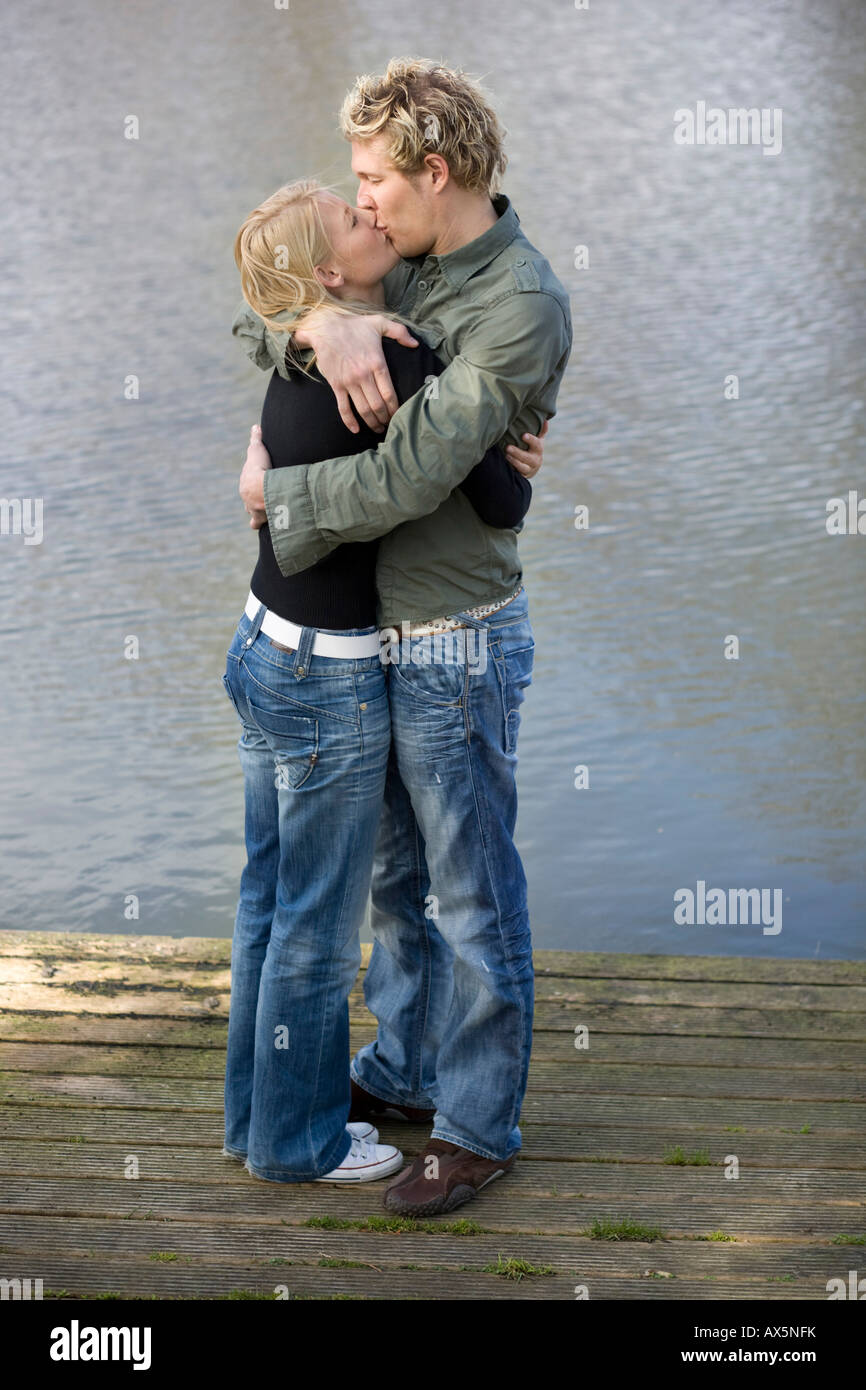 Couple hugging kissing on wooden hi-res stock photography and images ...