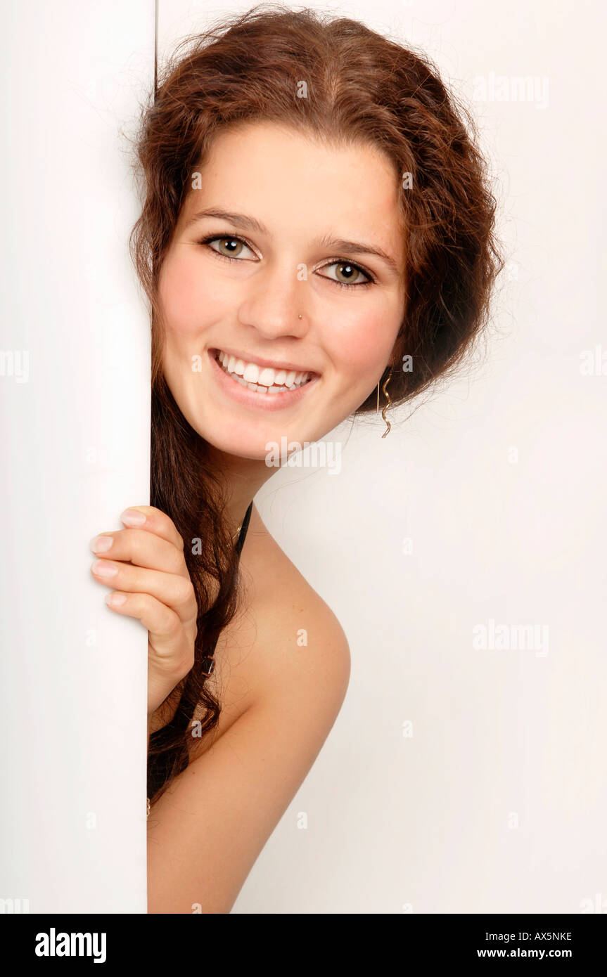 Woman peeking through door hi-res stock photography and images - Alamy