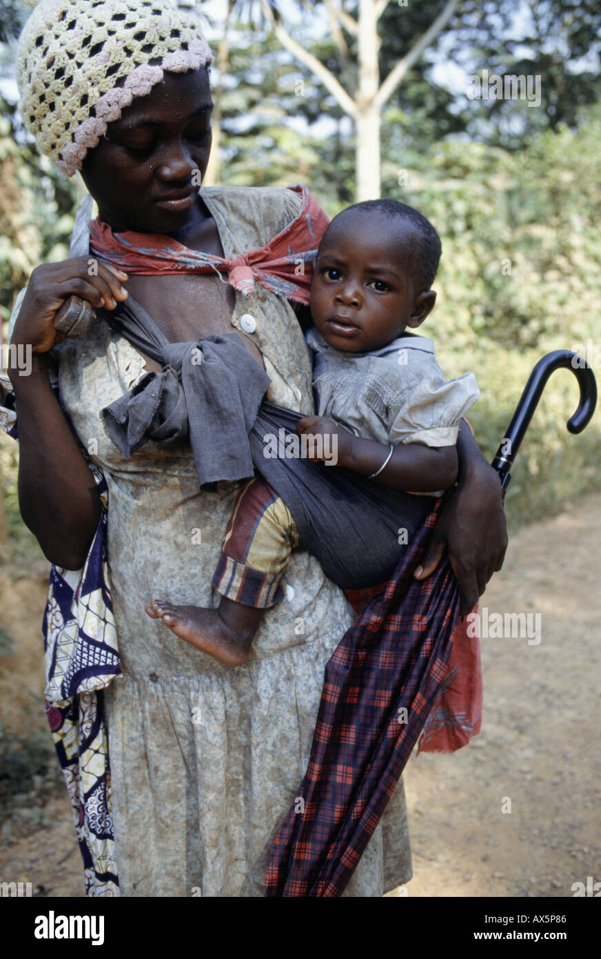 La Gongue, Gabon. Young Gabonese women with her baby son in a sling ...