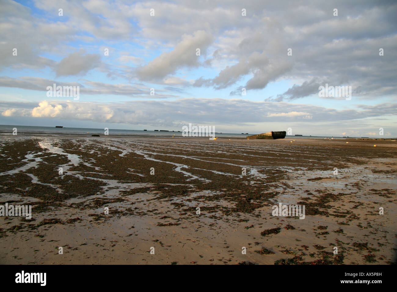 The beach at Arromanches Normandy with a stranded section of the ...