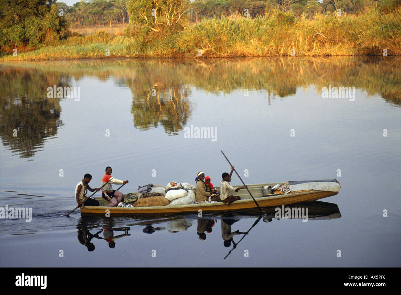 Mbati, Zambia, Africa. Losi tribespeople with laden canoe going to ...