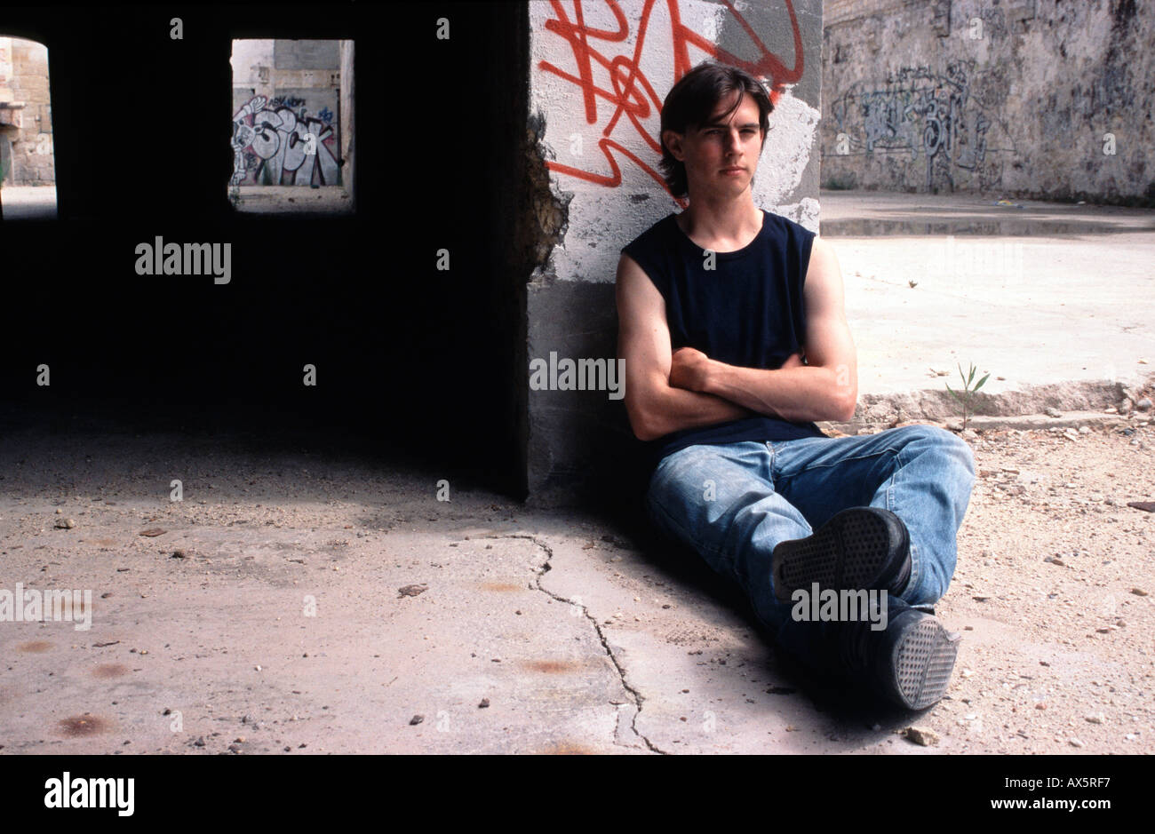 young boy sit on floor looking camera Stock Photo - Alamy