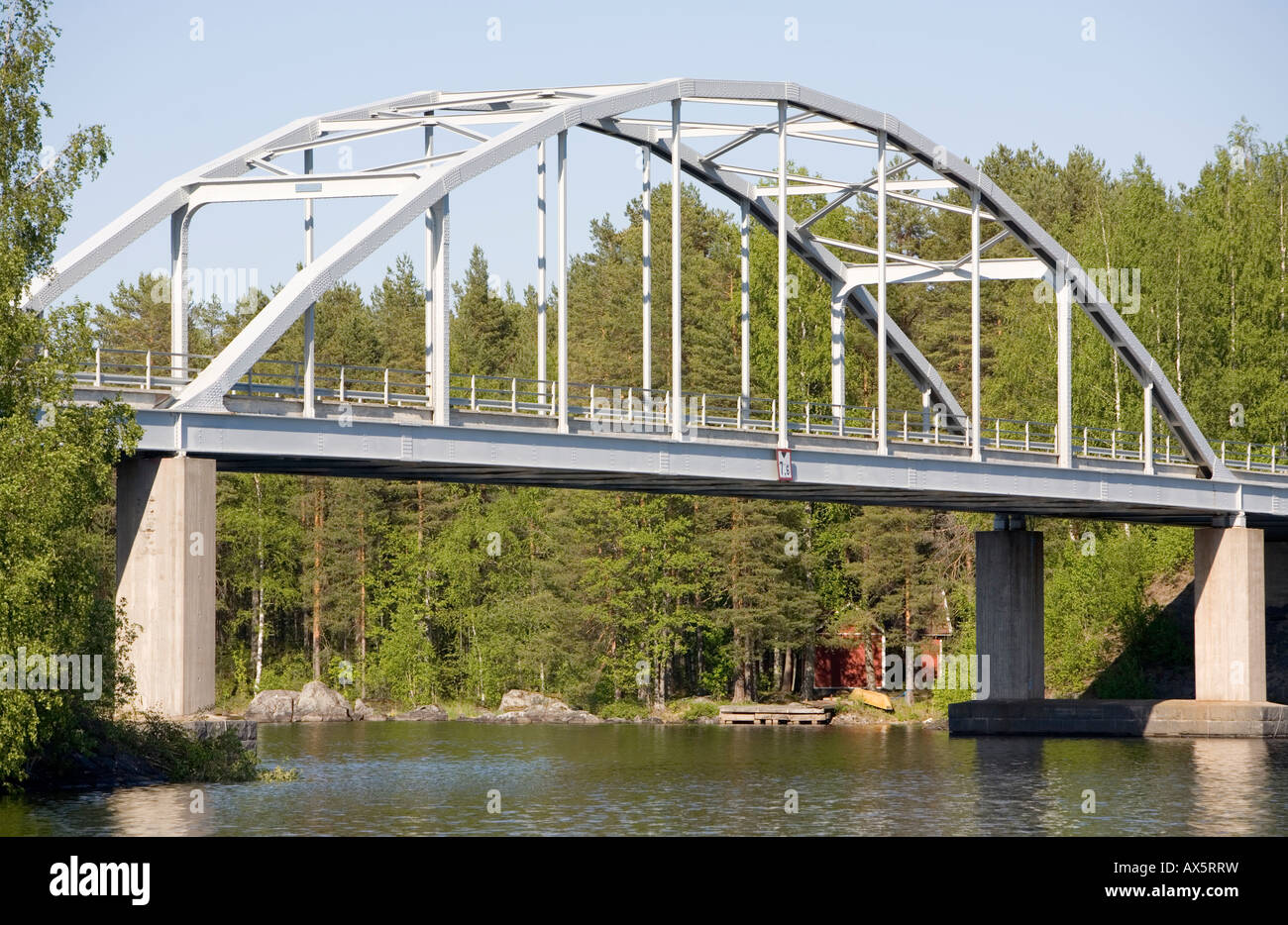 Finnish Steel arched road bridge over Kivisalmi strait at lake ...