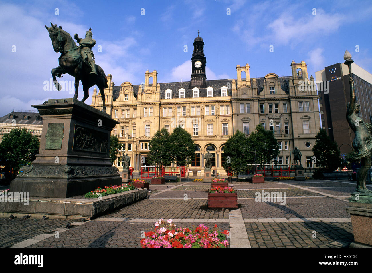 Beautiful flowers in the city square and statue of the Black Prince of ...