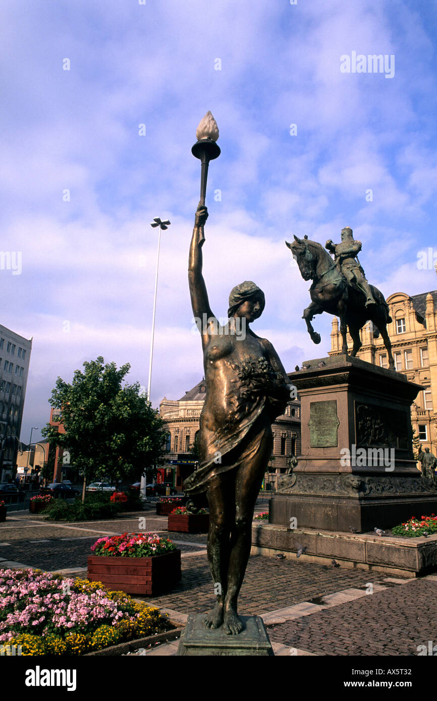 Beautiful flowers in the city square and statue of the Black Prince of ...