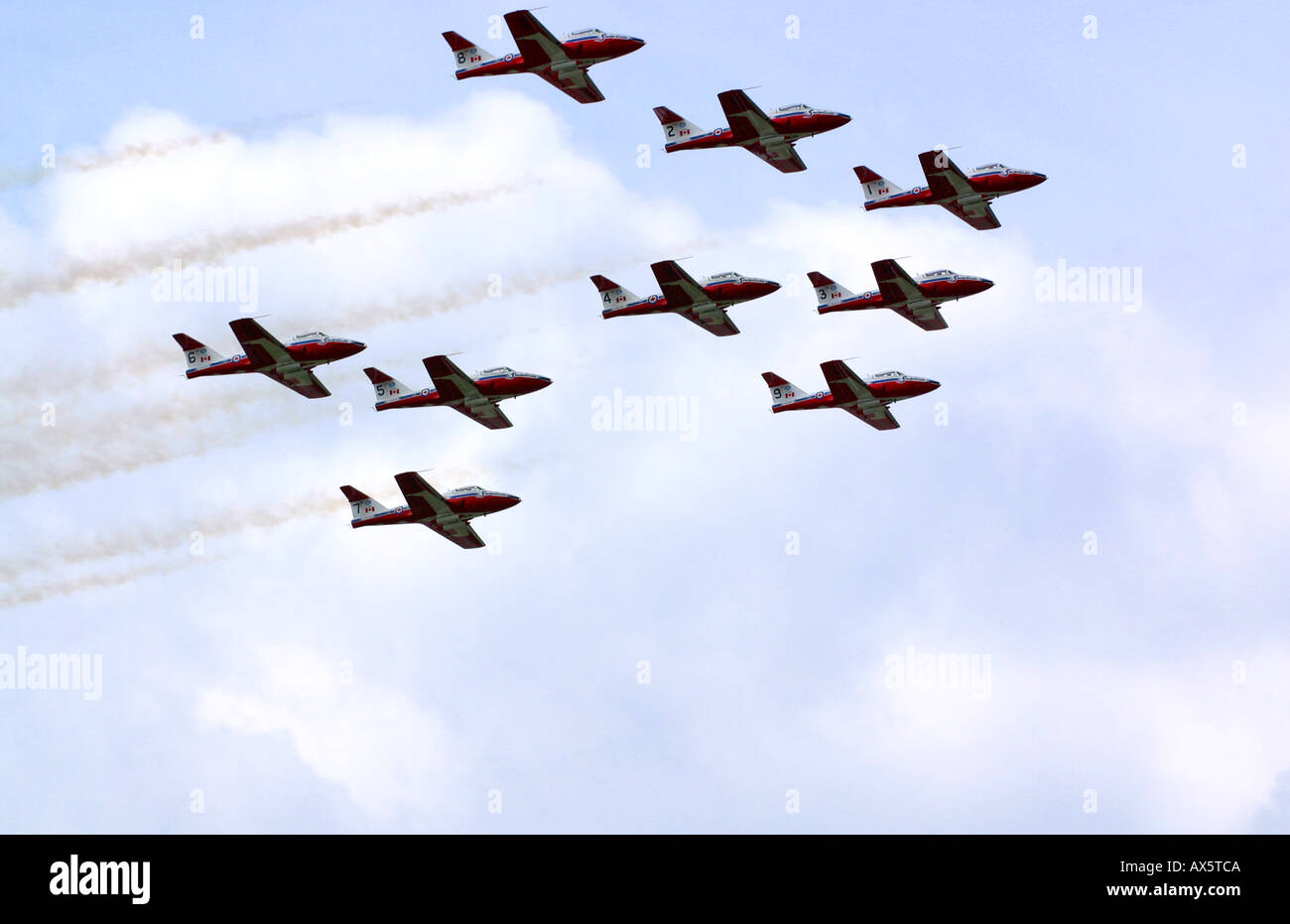 Nine of the red and white Canadian Snowbirds fly in formation leaving ...