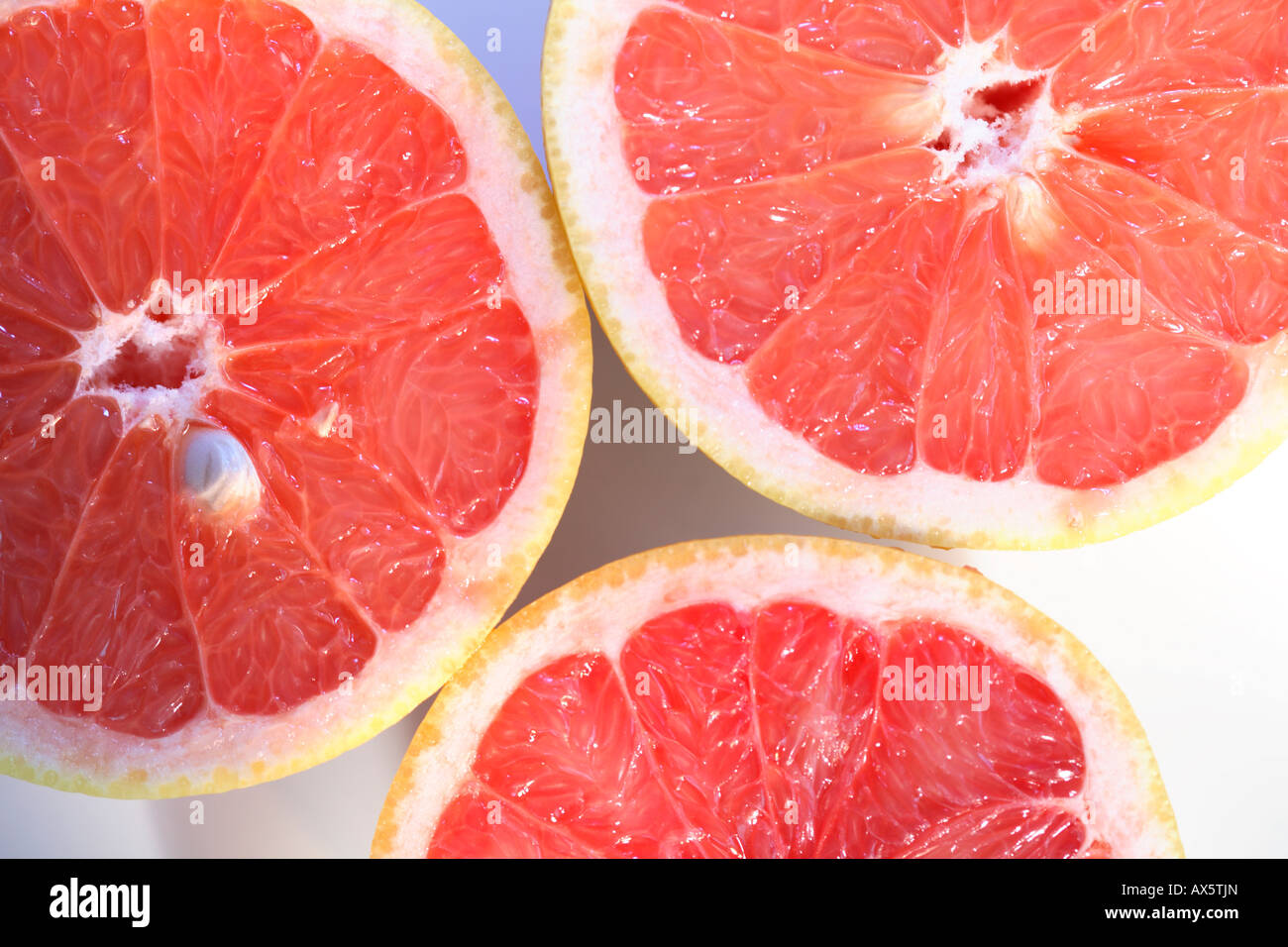 Three Grapefruits halves Stock Photo - Alamy