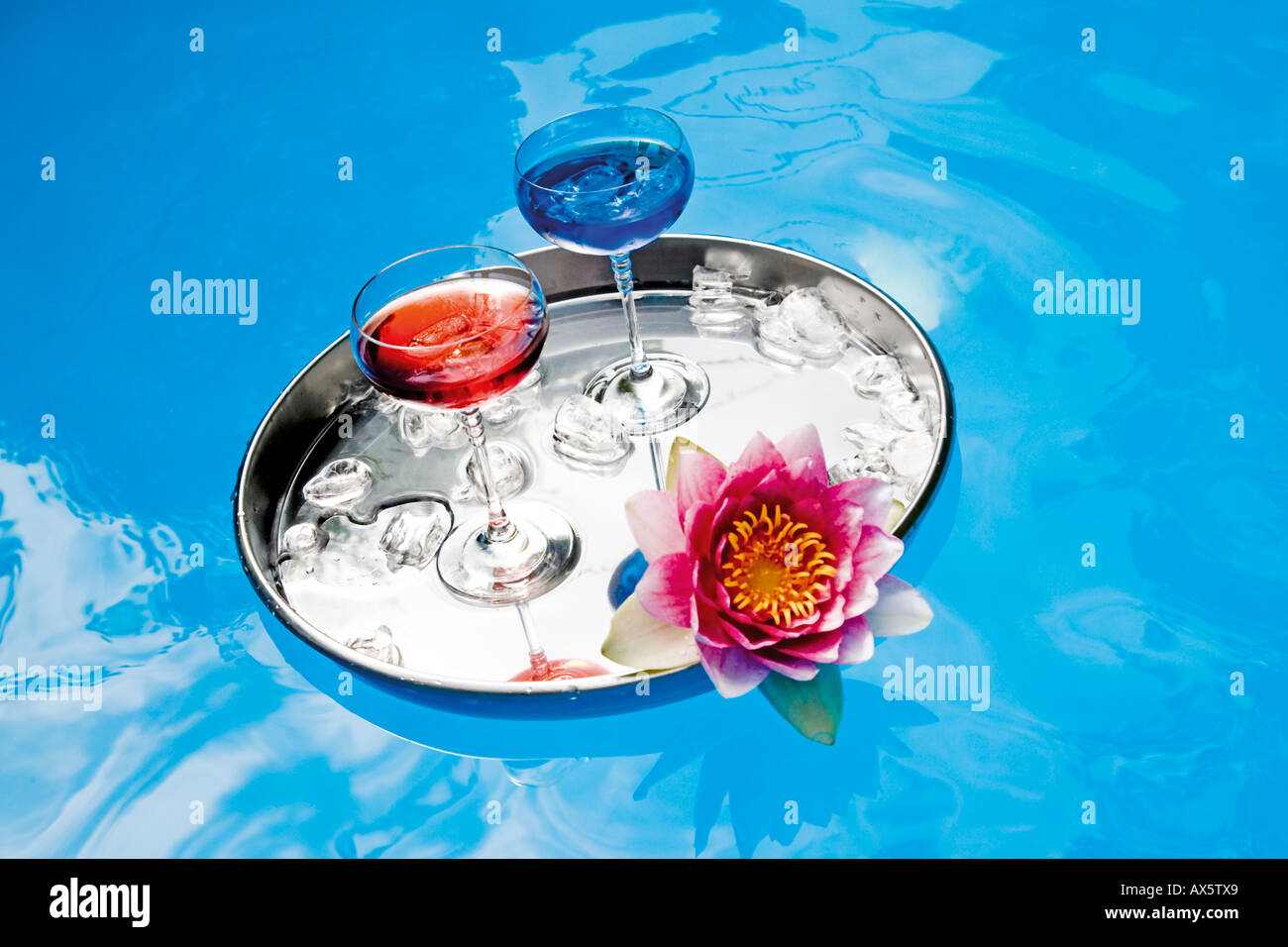 Drinks on tray floating in pool, elevated view Stock Photo - Alamy