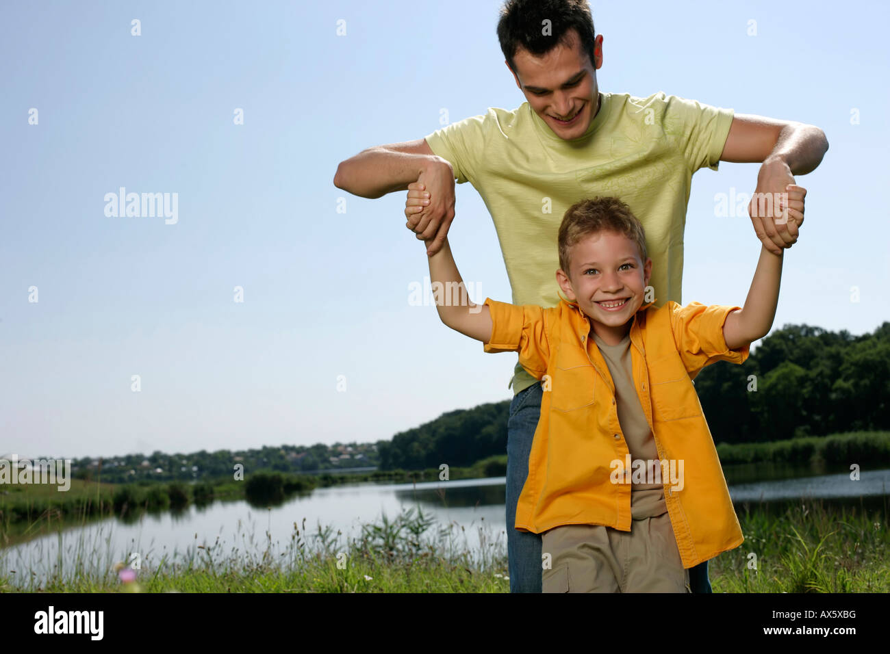Father and son holding hands and laughing Stock Photo - Alamy
