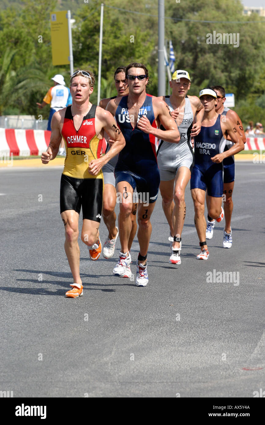 Various athletes out on the run section of the triathlon course along ...