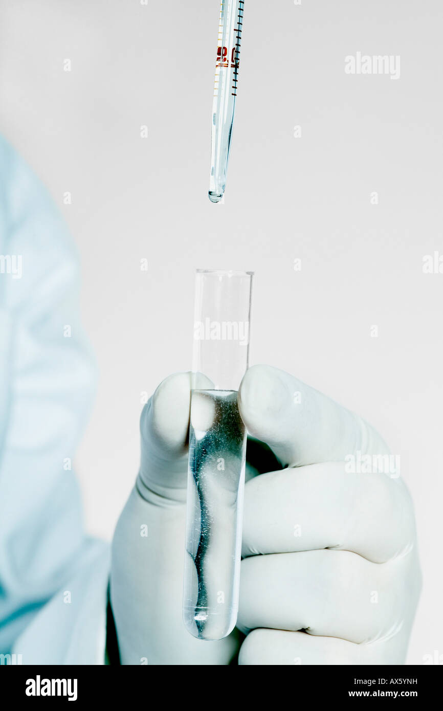 Chemist filling substance into a test tube with pipette Stock Photo - Alamy