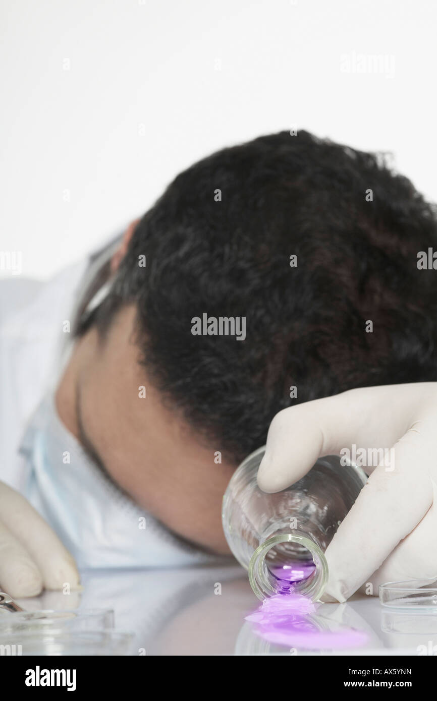 Chemist laying face down in laboratory, anaesthetised by liquid Stock ...