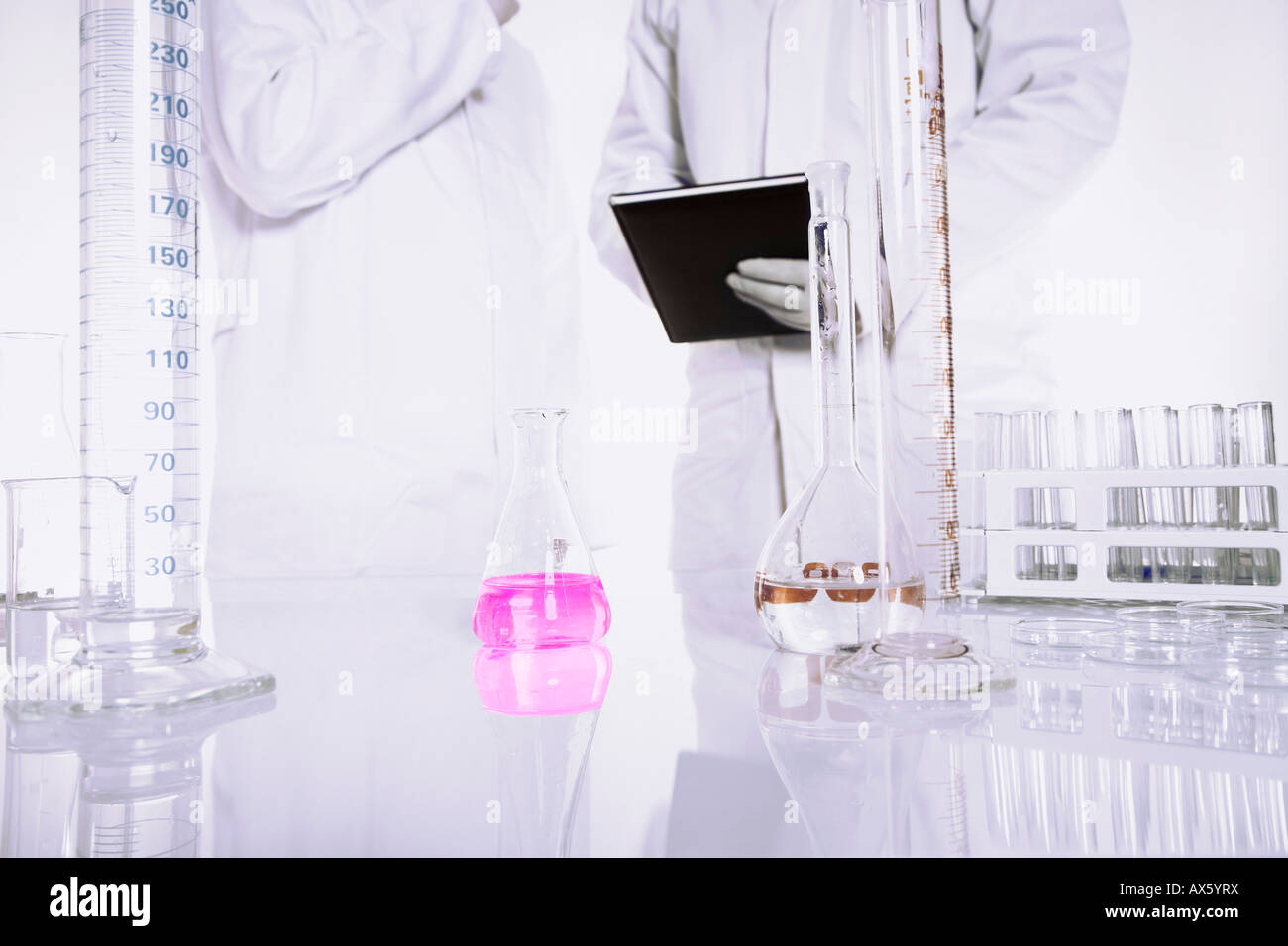 Scientists conducting chemical experiment hi-res stock photography and ...