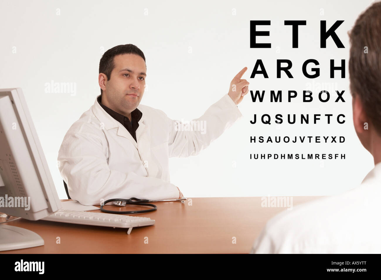 Optician conducting check-up, eyesight test Stock Photo - Alamy