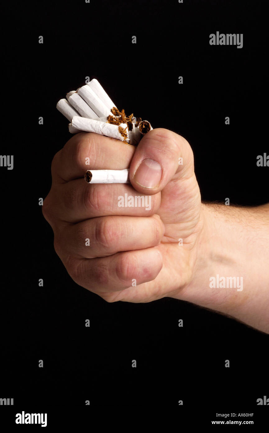 Man crushing cigarettes Stock Photo - Alamy