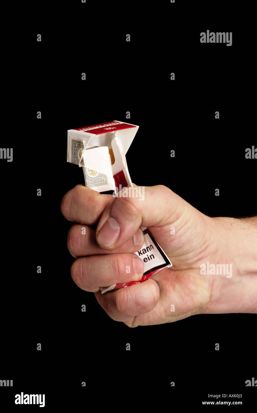 Man crushing cigarette box Stock Photo - Alamy