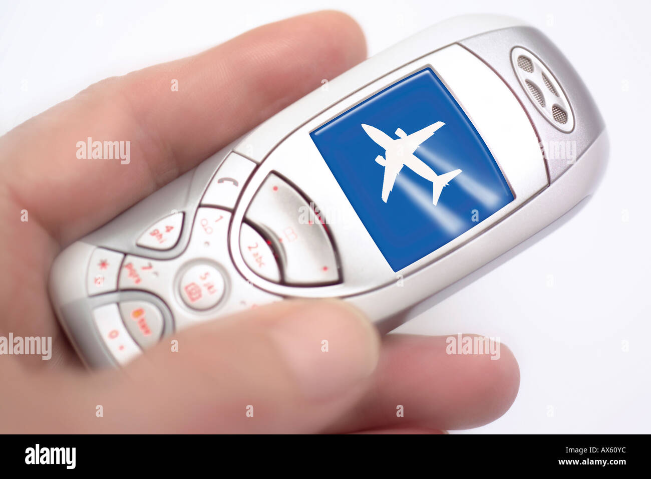 Mobile phone with airplane on display, symbol for mobile flight booking ...