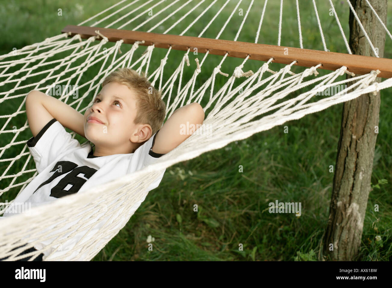 Boy lying in a hammock Stock Photo - Alamy