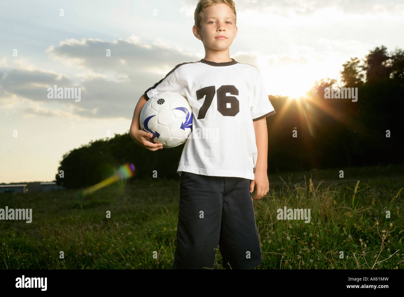 Boy holding a football under his arm Stock Photo - Alamy